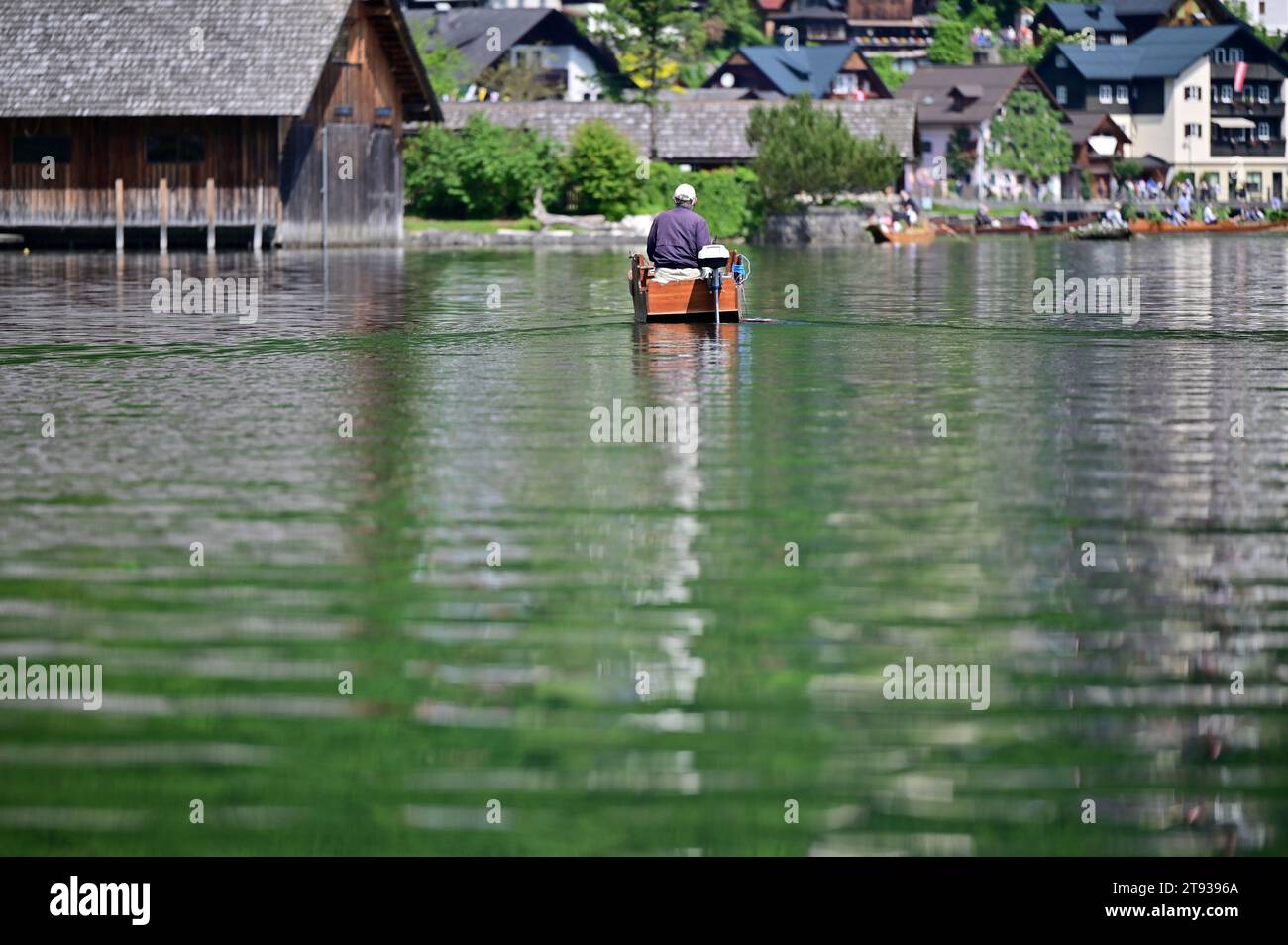 A small motor Ship on Lake Hallstatt with the typical waves Stock Photo ...