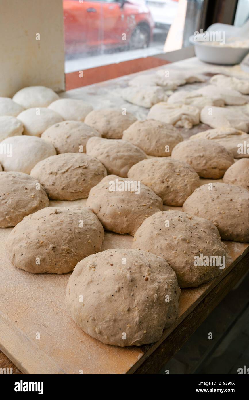 Portrait of several loaf-shaped bread doughs on a table in a bakery ...