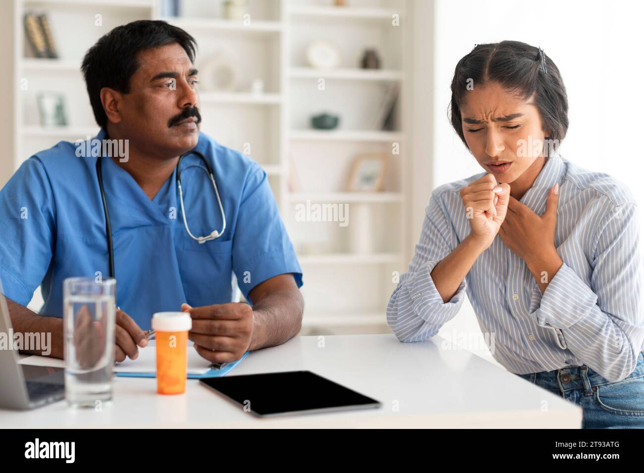 Sick Young Indian Woman Coughing During Meeting With Male Doctor In ...