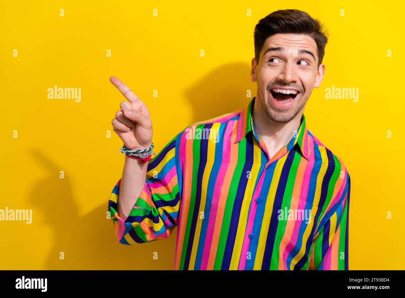 Photo of young gentleman boyfriend amazed directing finger empty space ...