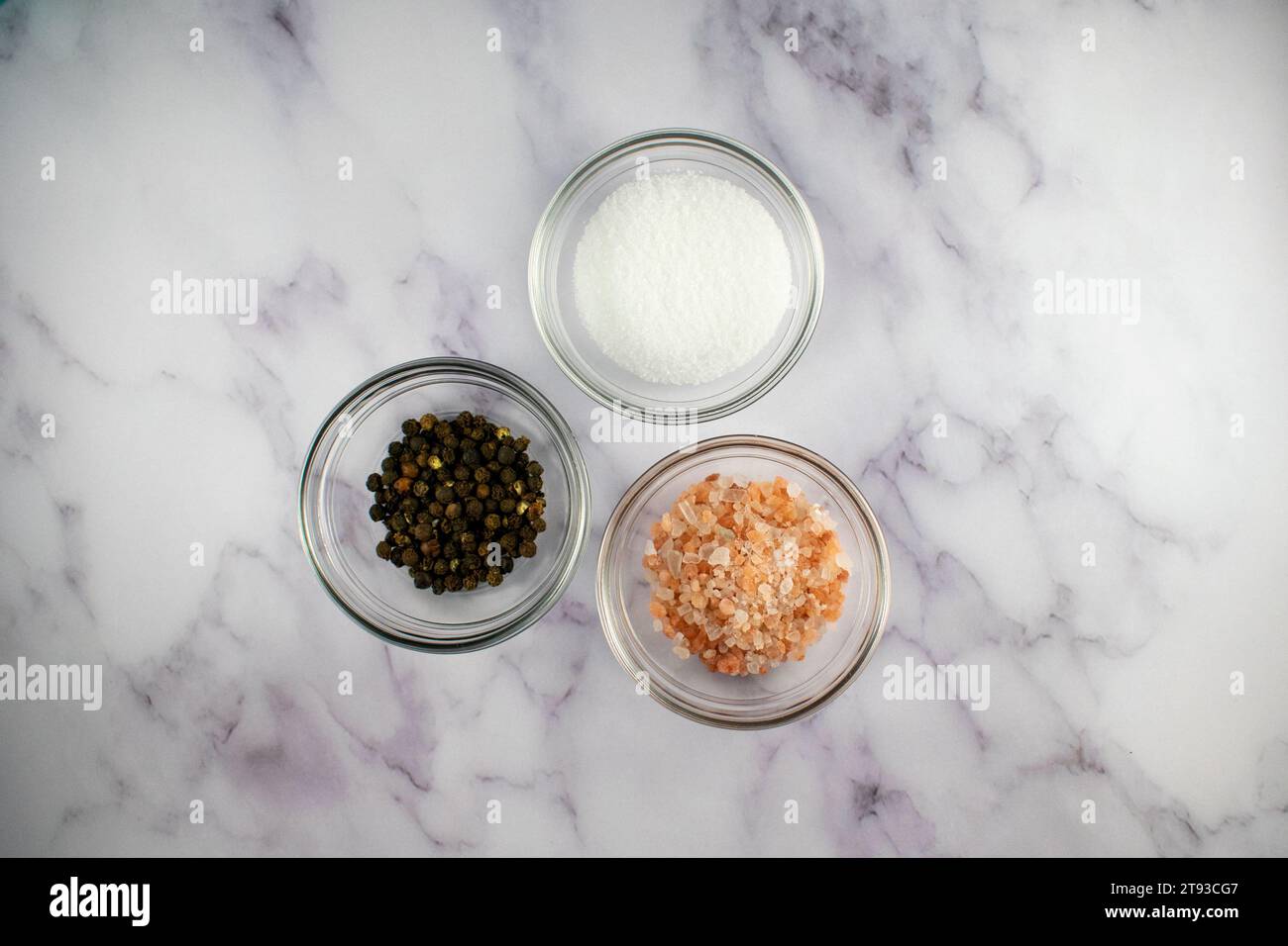 Top down flat lay photo showing salt, Himalayan pink salt, and black ...