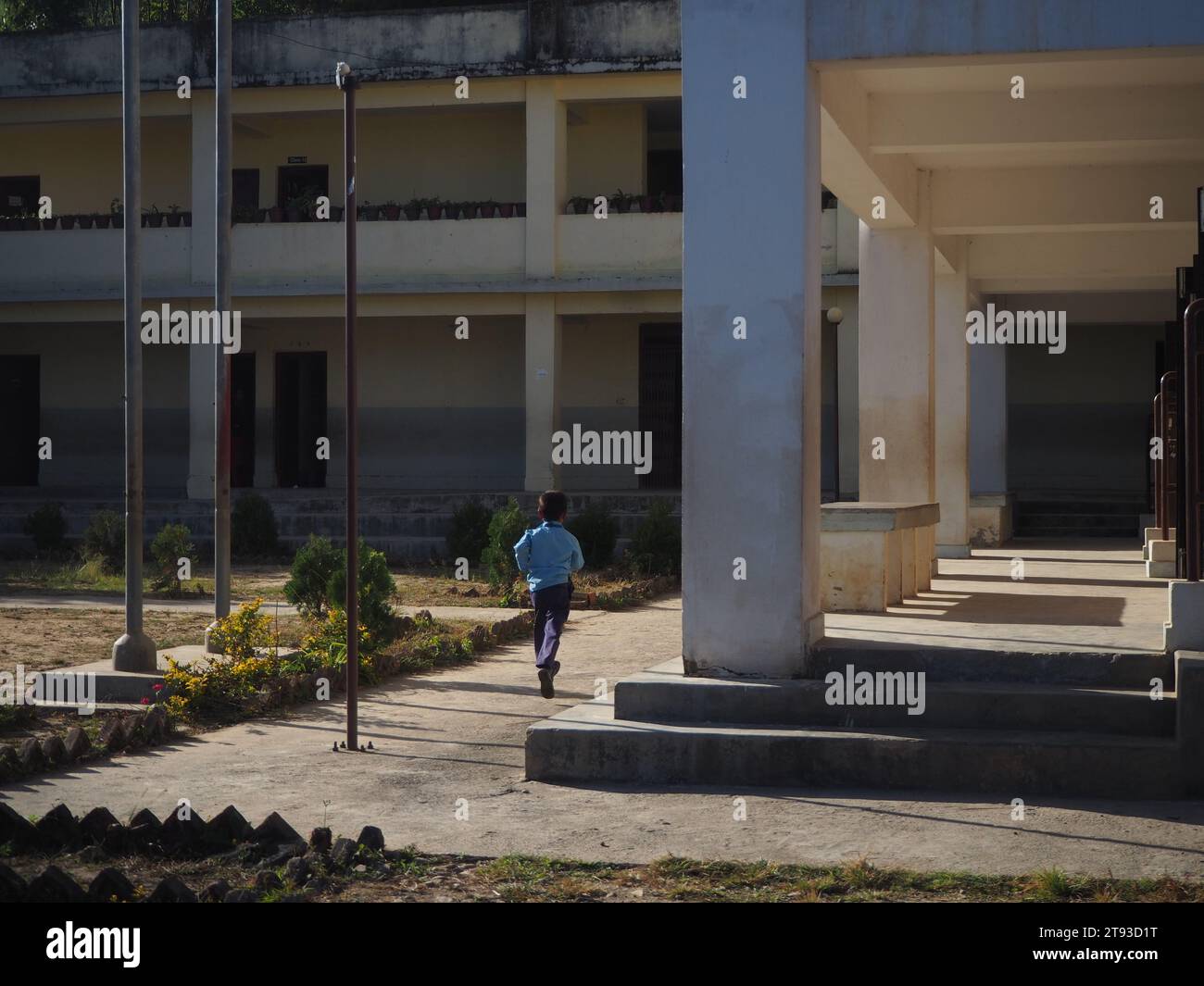 An anonymous child from behind, running in his schoolyard in Nepal. He ...