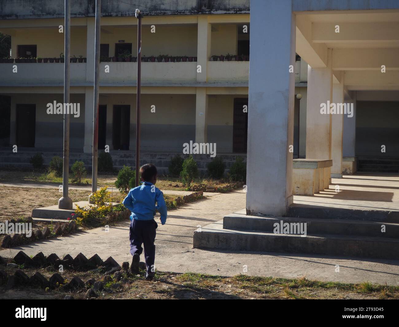 An anonymous child from behind, running in his schoolyard in Nepal. He ...