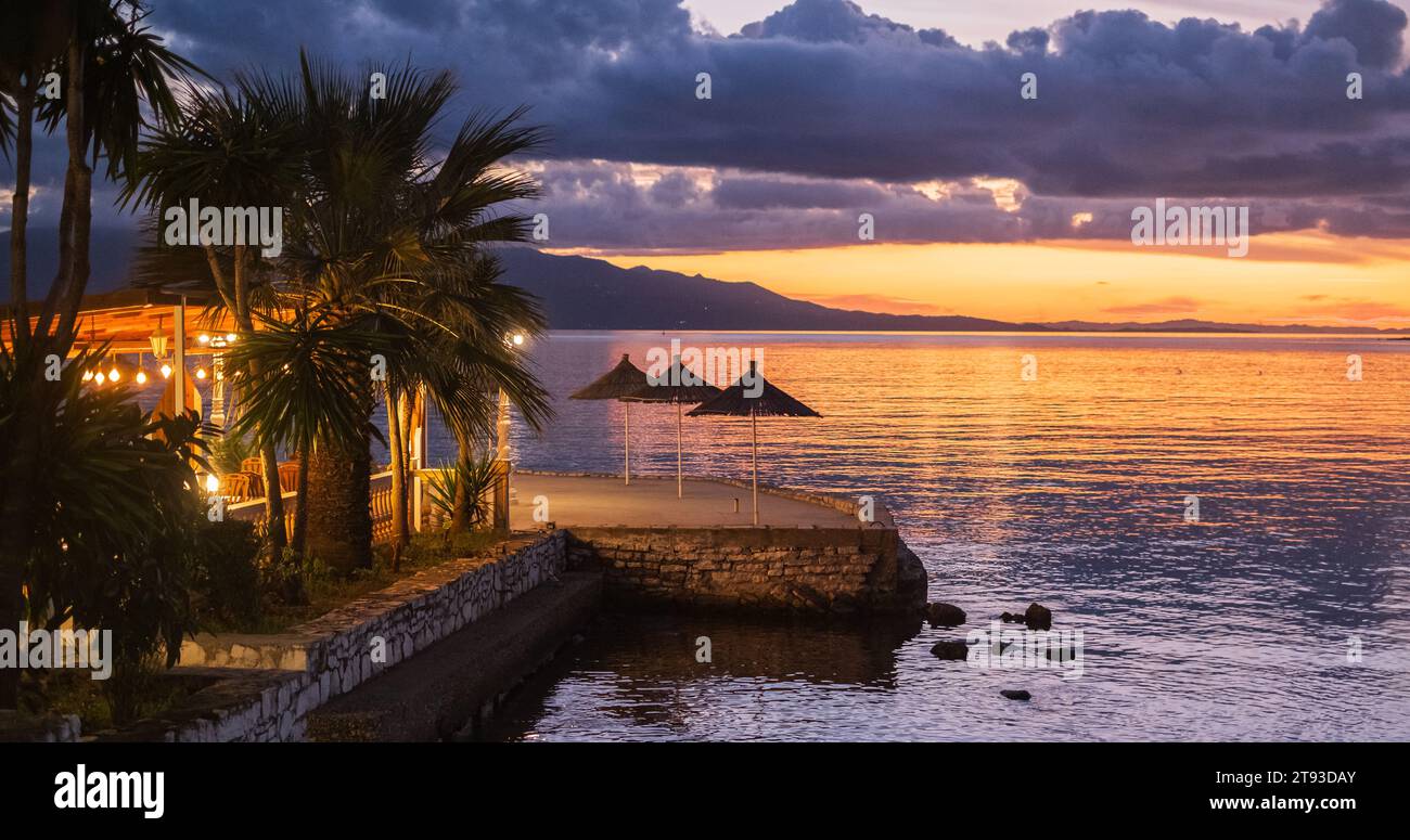 Beautiful tropical sunset scenery, umbrellas with palm tree. sea view ...