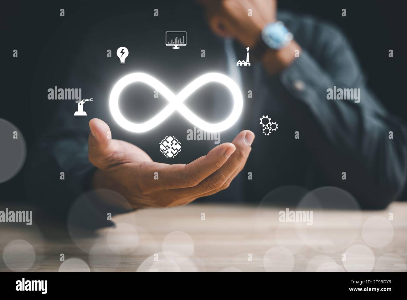 Circular infinity symbol in businessman's hand on dark background Stock ...