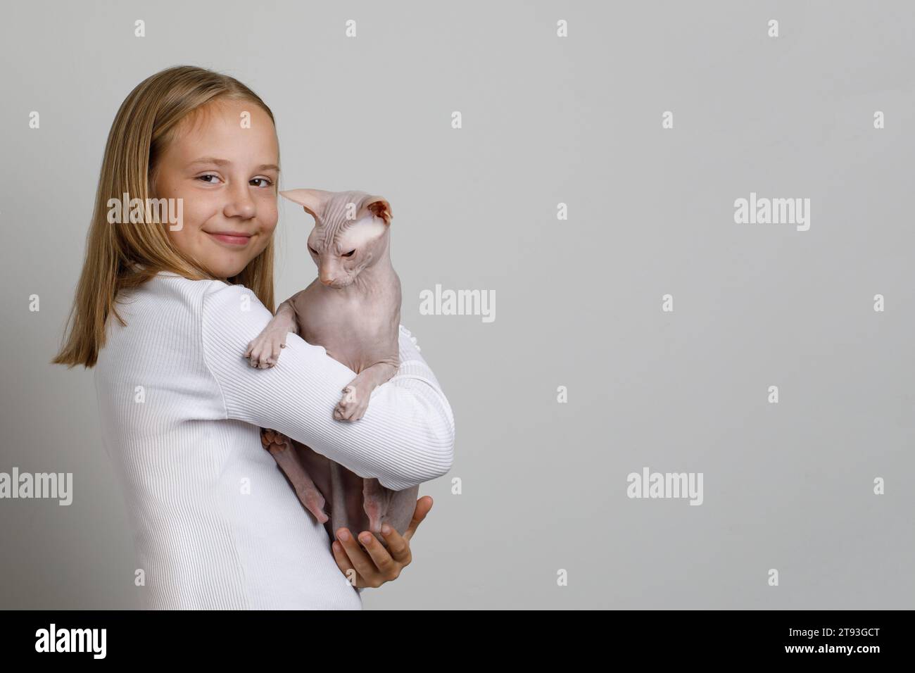 Little kid girl with cat pet on white background, studio portrait Stock ...