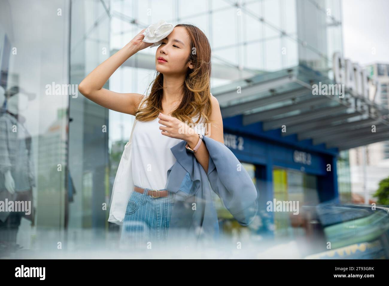 Asian beautiful business woman drying sweat her face with cloth in warm ...