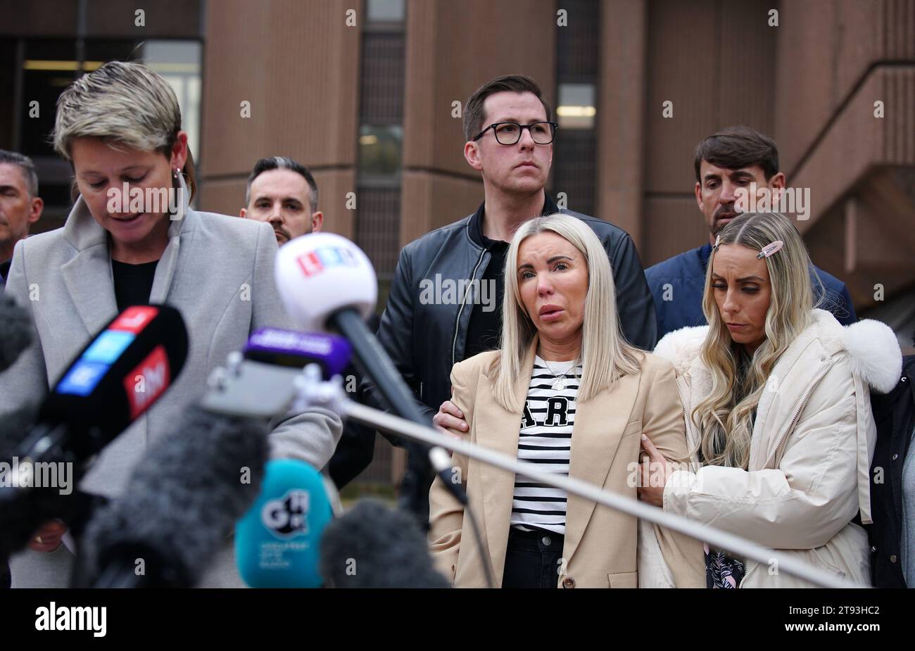 Ashley Dales' mother Julie Dale (centre right) listens as a statement ...