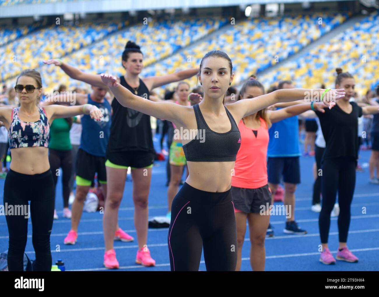 Large group of people doing morning exercises on the stadium. September ...