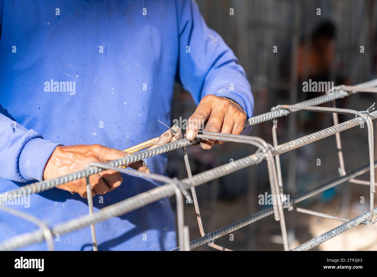 Worker bundle wire steel rod for construction job in building site ...