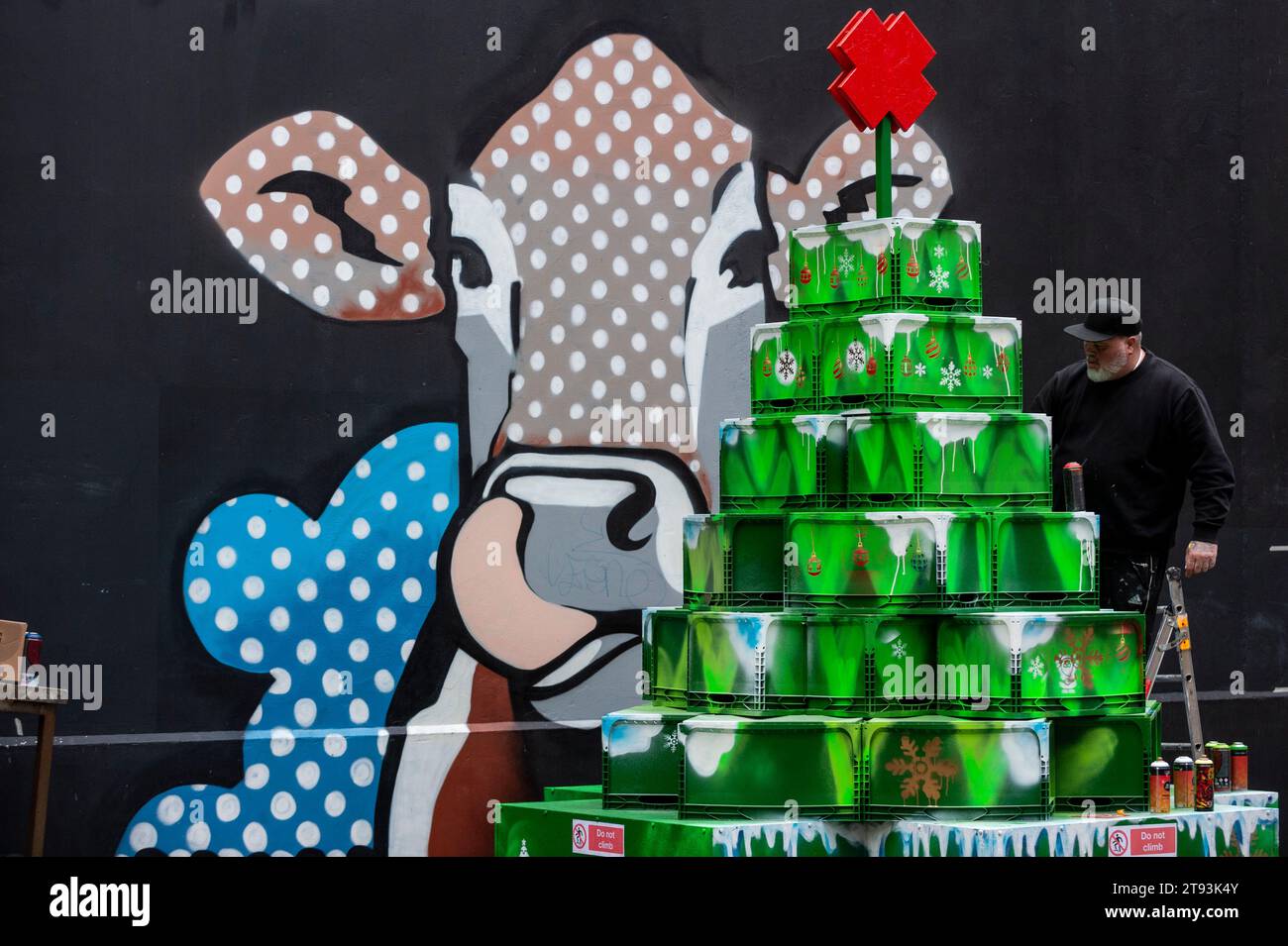 London, UK. 22 November 2023. A graffiti artist at work at the ...