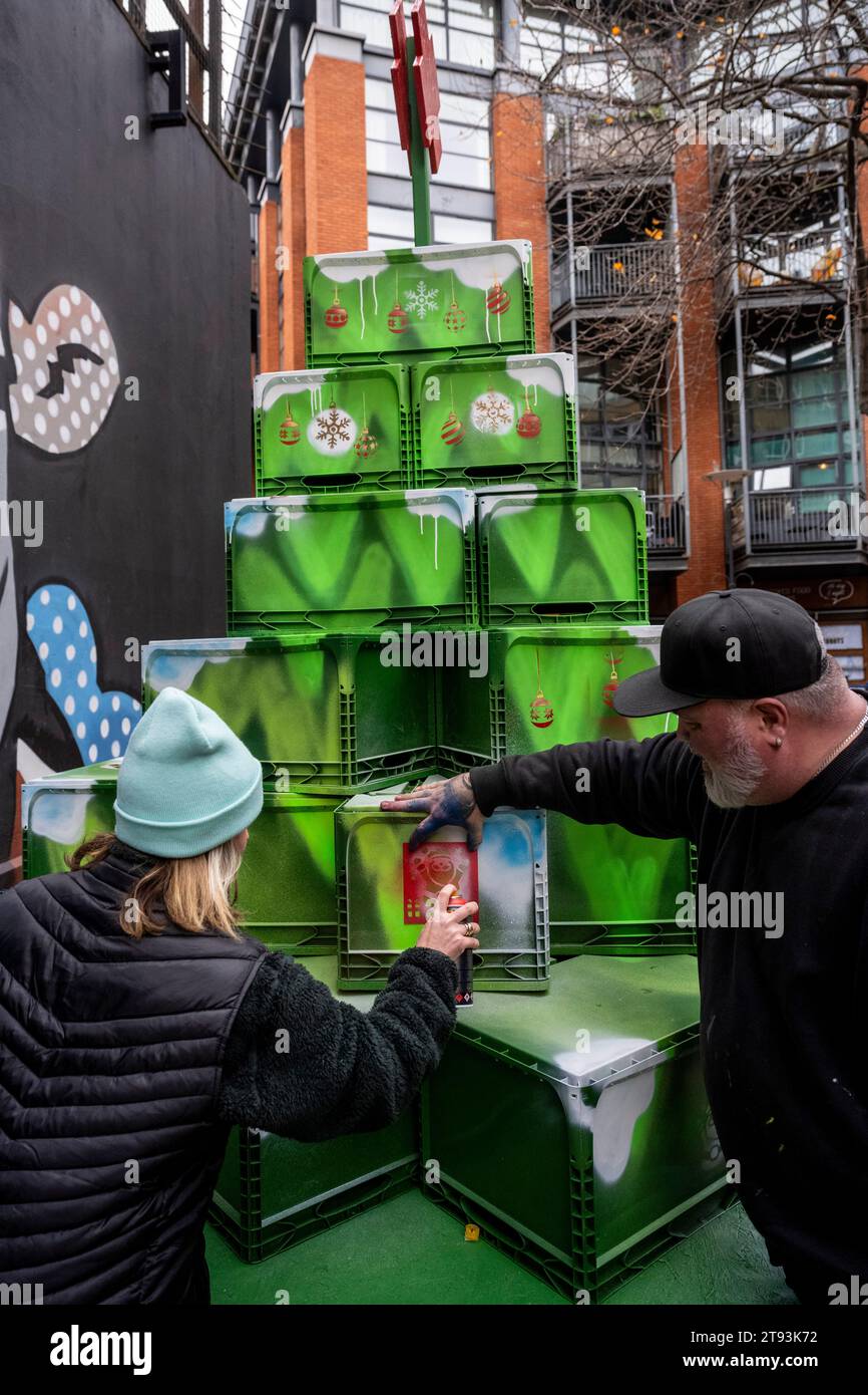 London, UK. 22 November 2023. A graffiti artist and visitor at the ...