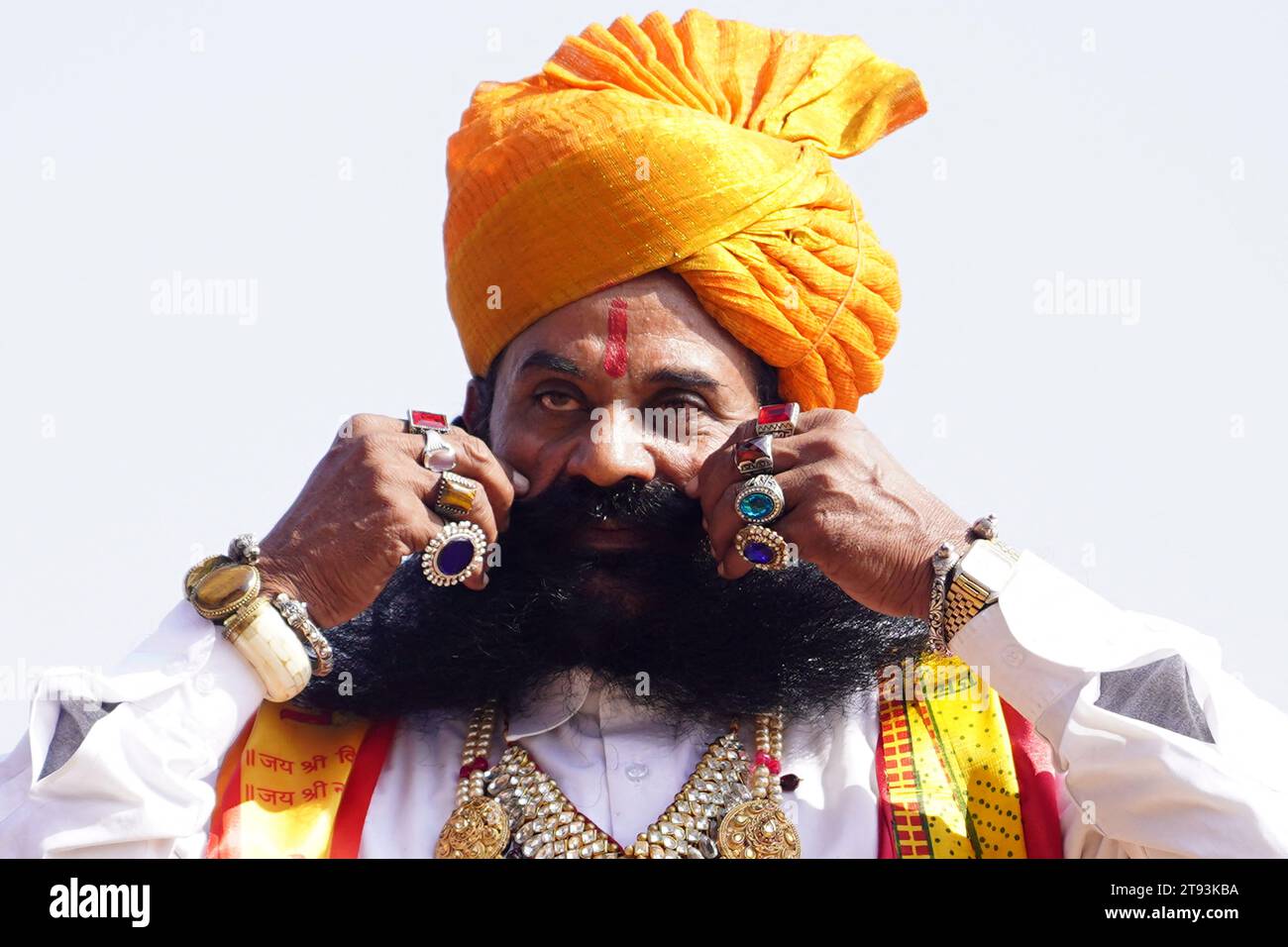 Pushkar, India. 22nd Nov, 2023. A man shows his long moustache during a competition at fair In ...