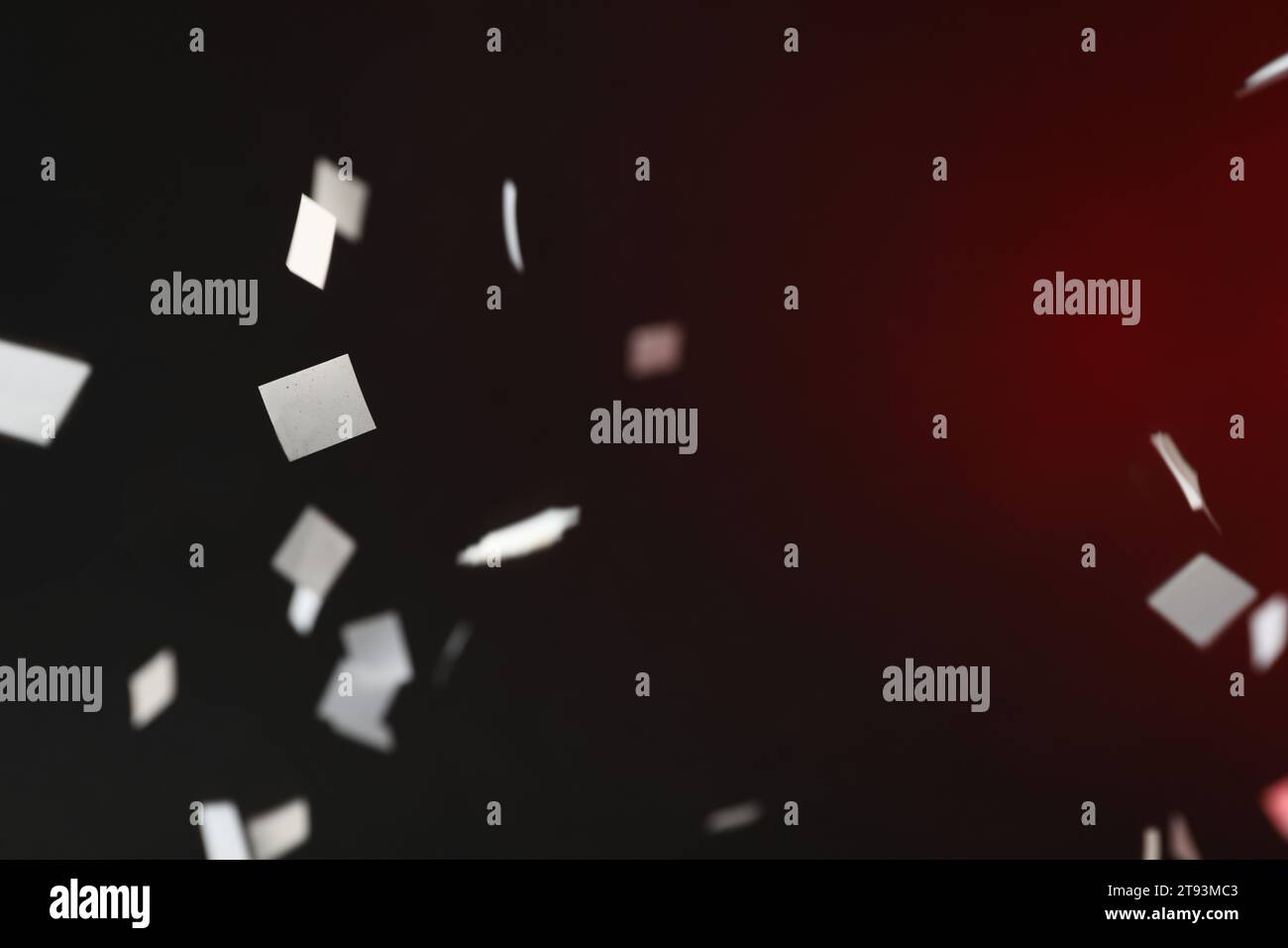 White confetti falling down, toned in red Stock Photo - Alamy
