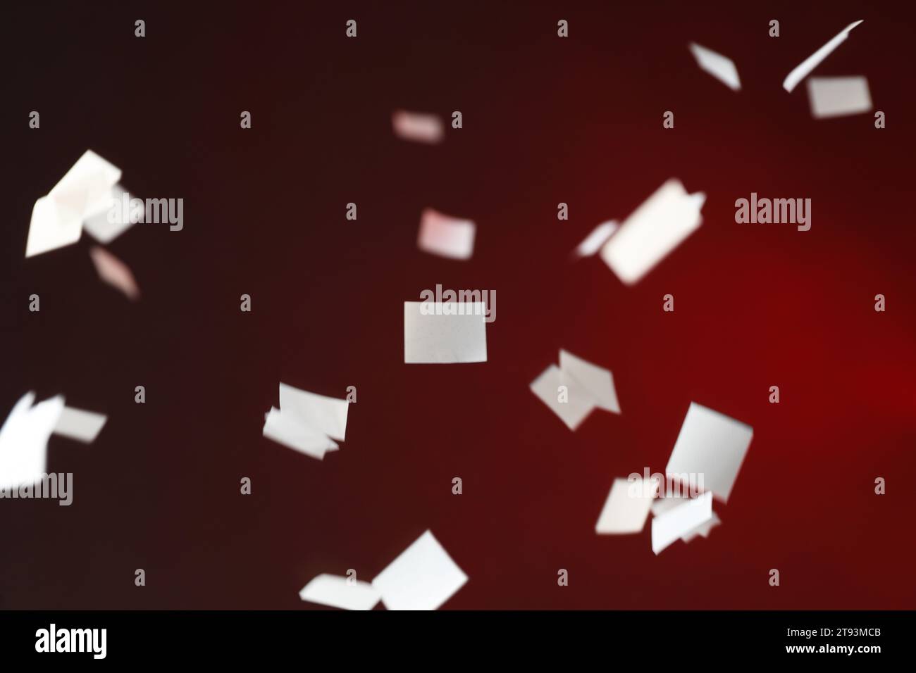 White confetti falling down, toned in red Stock Photo - Alamy