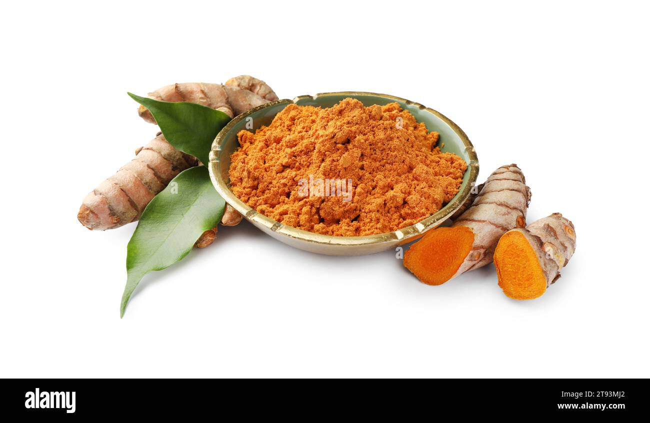 Bowl of aromatic turmeric powder, leaves and raw roots isolated on ...