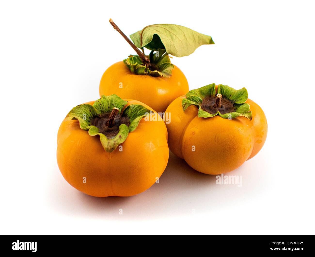 Photo of a ripe fuyu Asian persimmon with leaves and stem intact Stock ...
