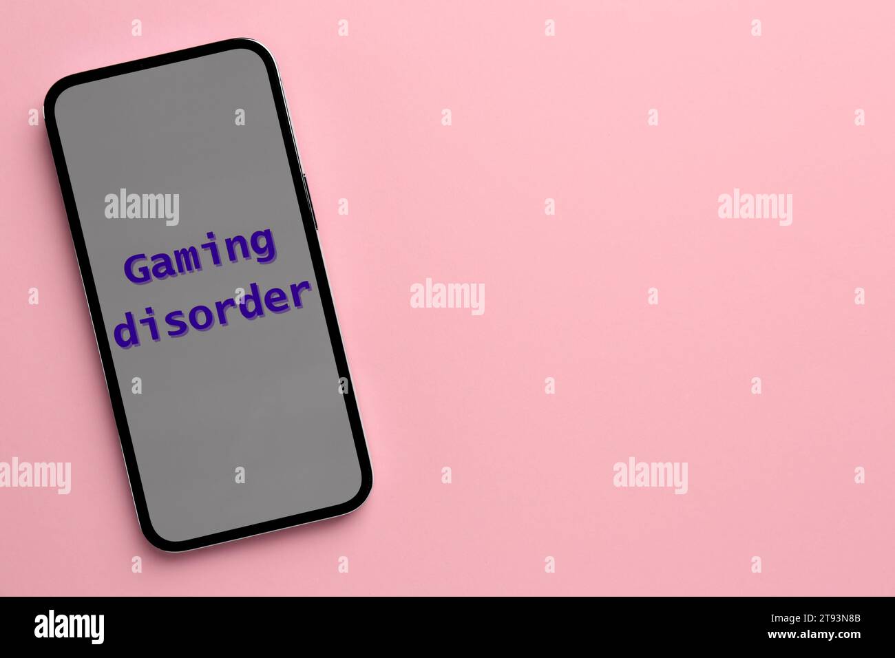 Smartphone with phrase Gaming Disorder on pink background, top view and ...