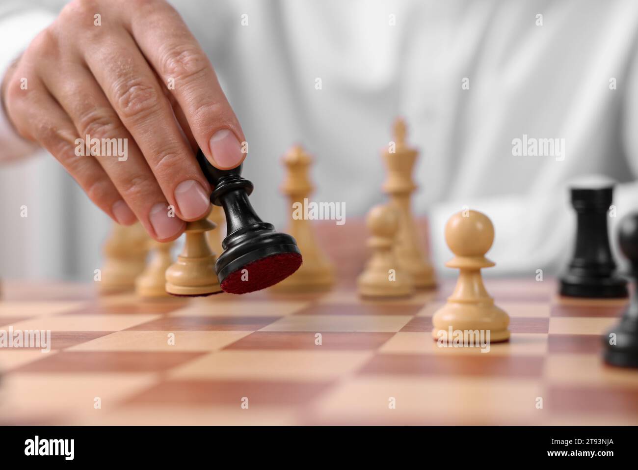 Man moving chess pieces at checkerboard, closeup Stock Photo - Alamy