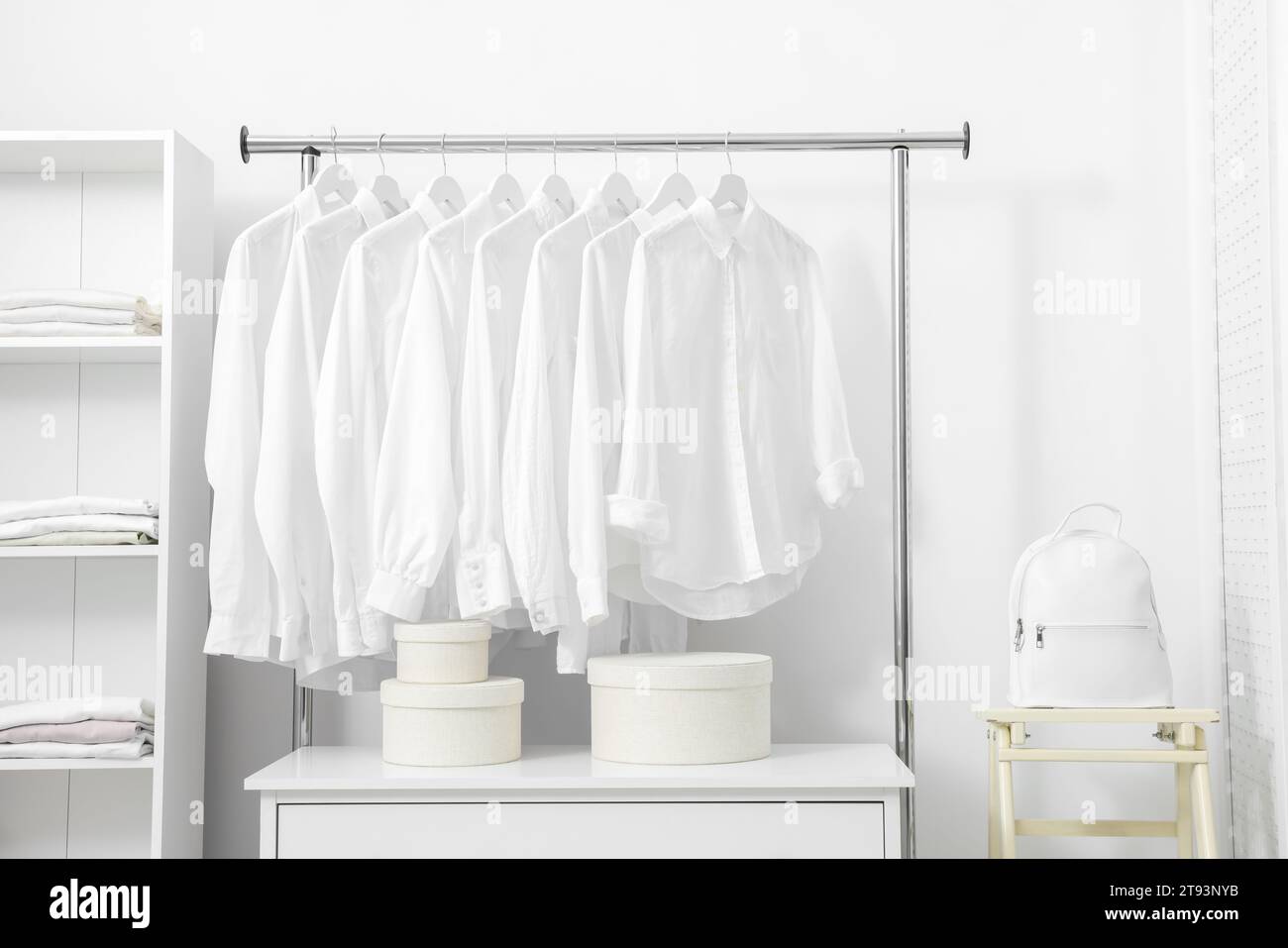 Wardrobe organization. Rack with different stylish clothes, shelving ...