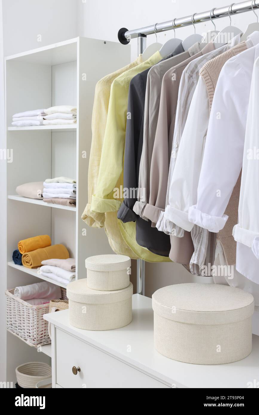 Wardrobe organization. Rack with different stylish clothes, shelving ...