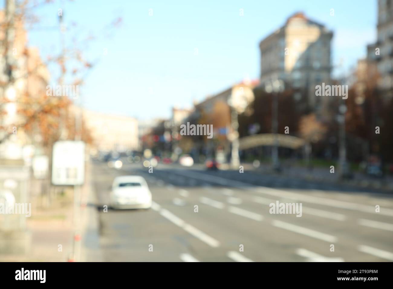 Blurred view of quiet city street with buildings and cars on road Stock ...