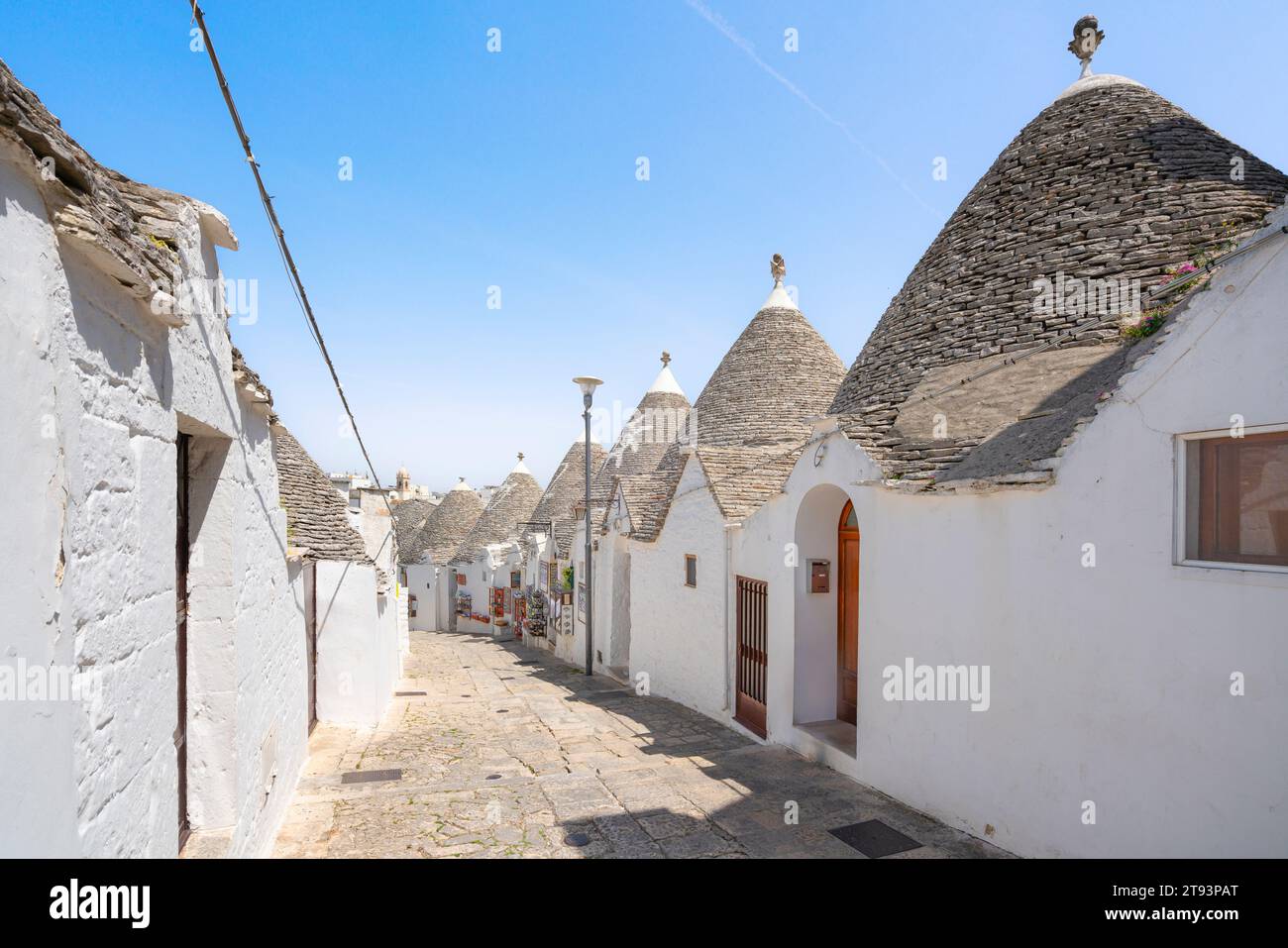 Trulli traditional Apulian dry stone hut with conical roof. Street view ...