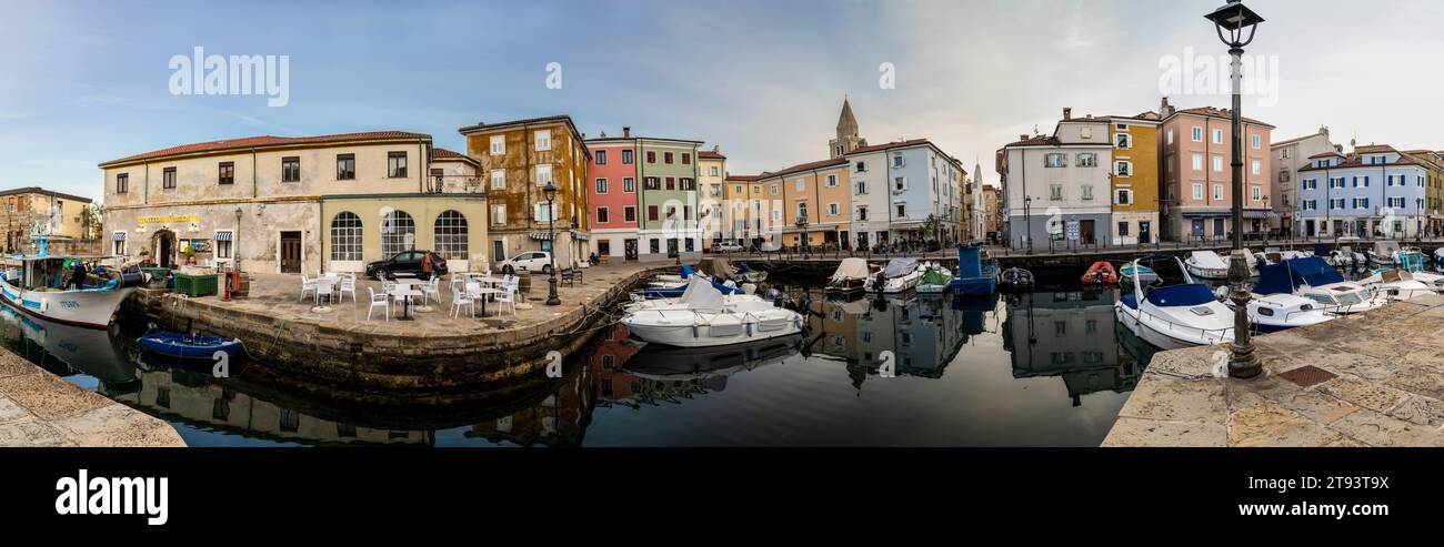 Muggia, Italy – November 18, 2023. Panoramic shot of the old harbour of ...