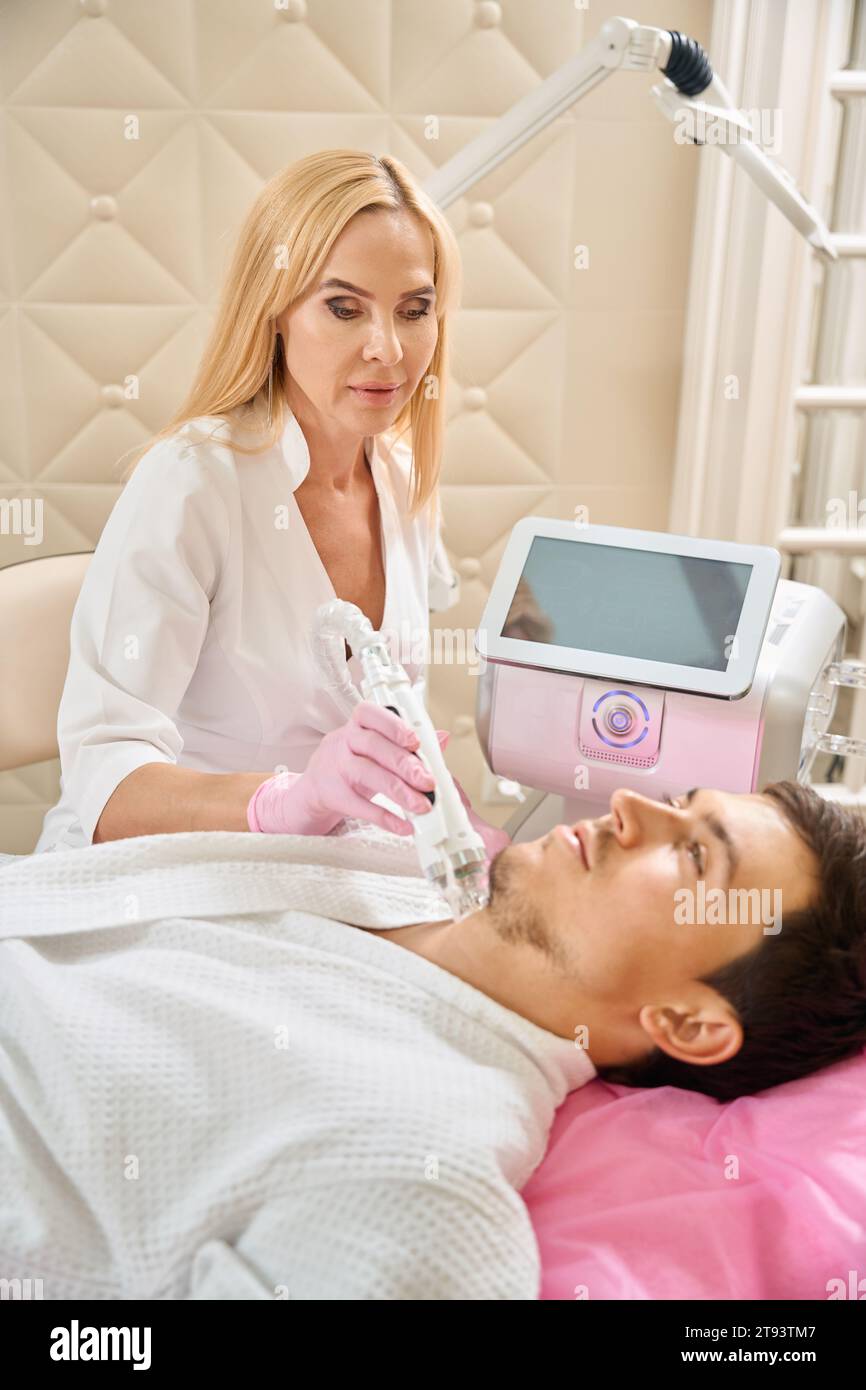Doctor performs a microneedle RF lifting procedure for neck area Stock ...