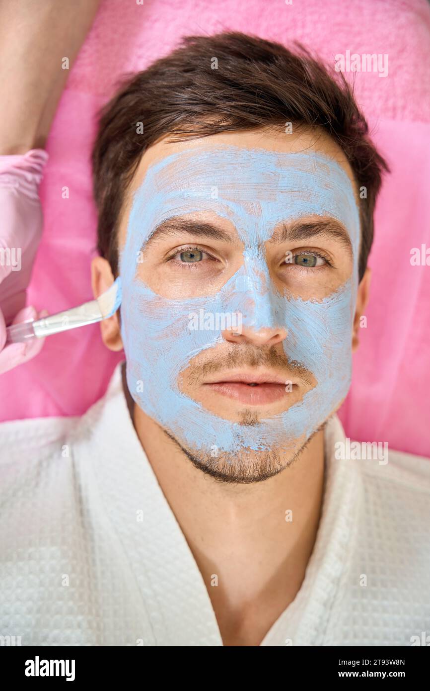 Client is given a face mask in aesthetic medicine clinic Stock Photo ...