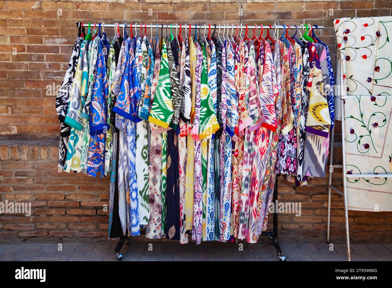 Uzbek traditional clothes such as robes and other colorful souvenirs ...