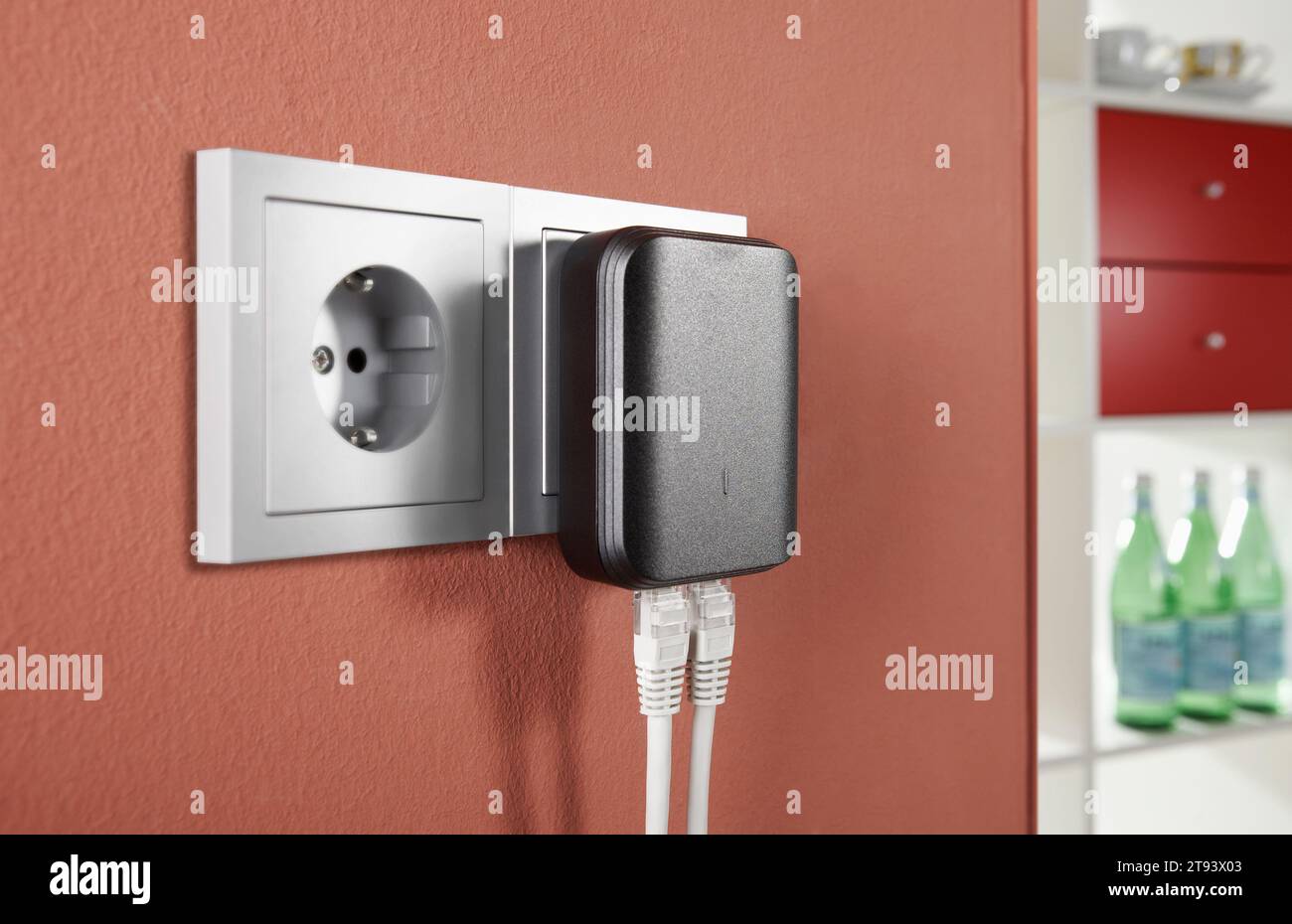 WiFi repeater in a wall plug on a red wall Stock Photo - Alamy