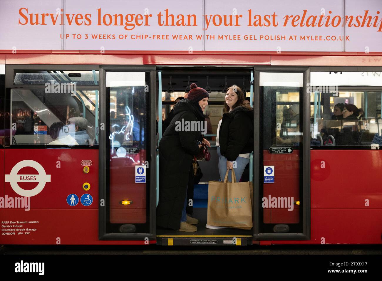 London commuters on a London Bus at dusk on Oxford Street in London's ...