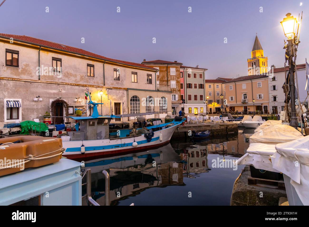 Evening atmosphere in the old harbour of Muggia, a coastal town near ...