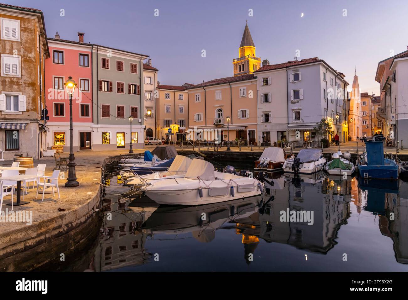 Evening atmosphere in the old harbour of Muggia, a coastal town near ...
