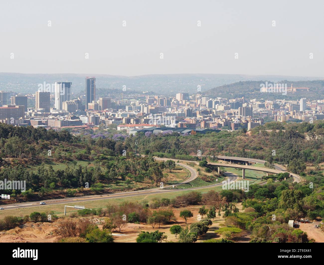The city of Pretoria seen from a distance with highways and nature in ...