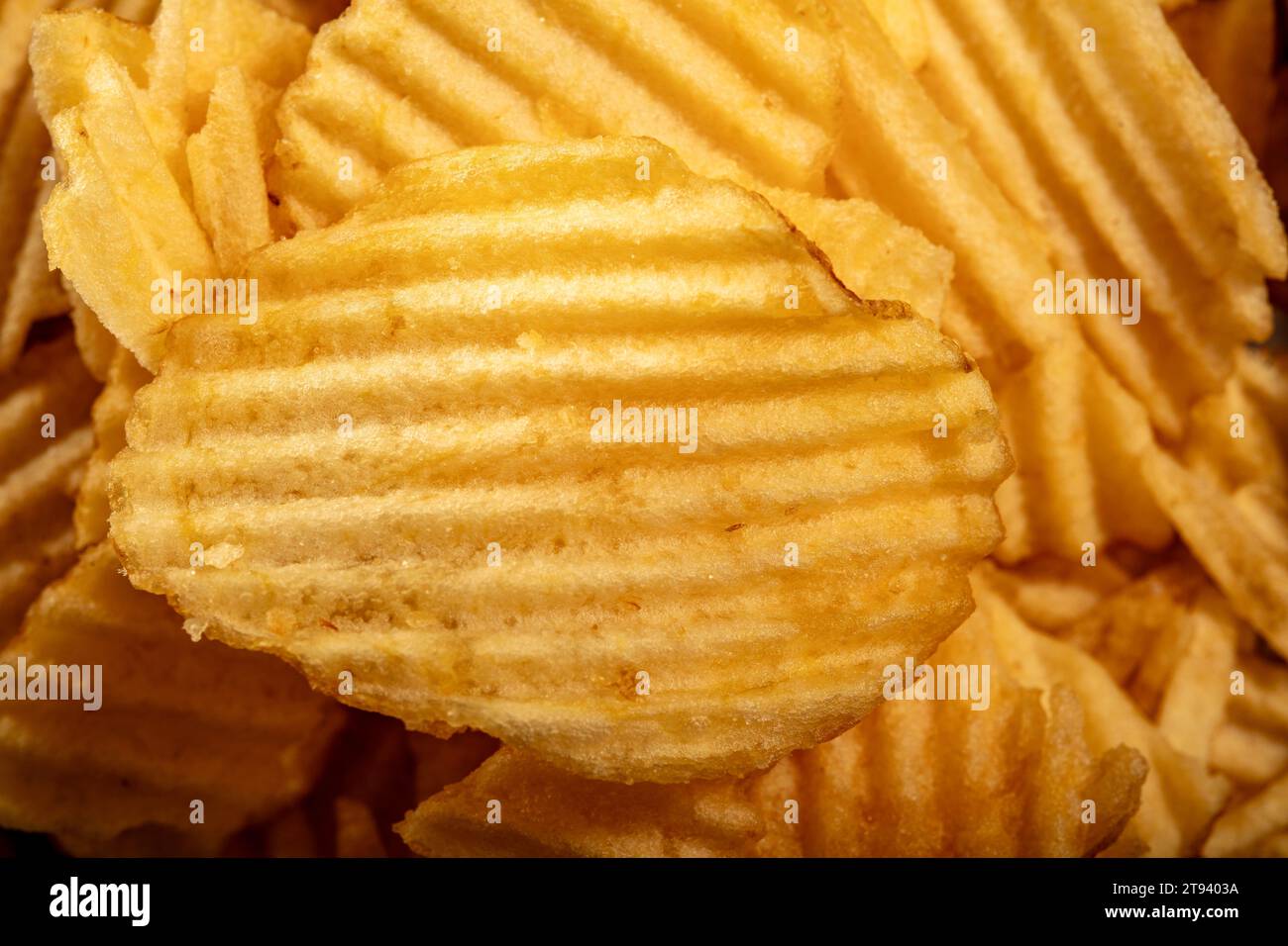 Close up snack food still life of crinkle cut crisps Stock Photo - Alamy