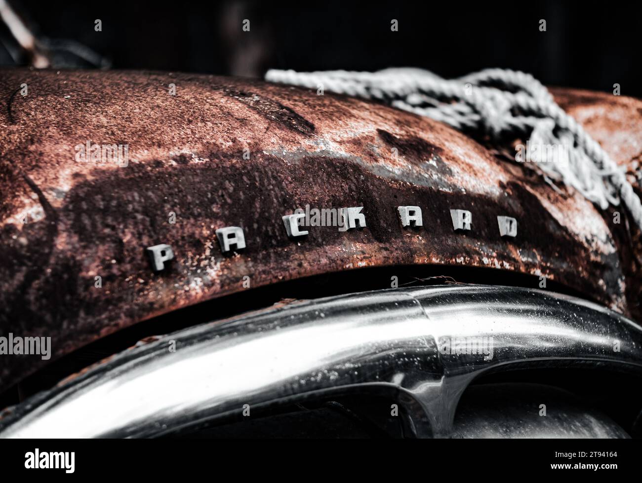 A close-up shot of an aged car emblem, featuring a rusty, worn-out ...