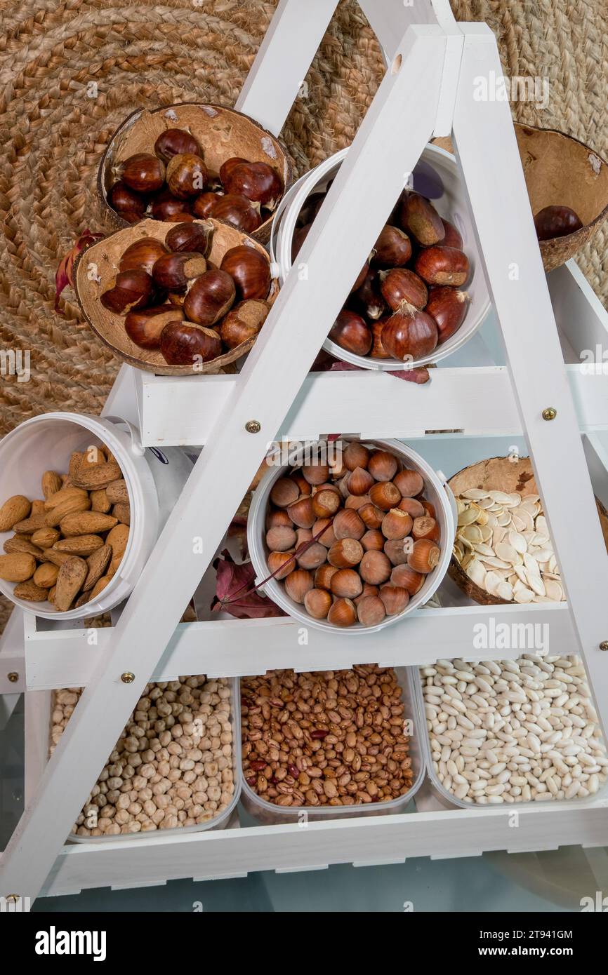 Homemade autumn/winter pantry with legumes and nuts. Shelf with beans ...