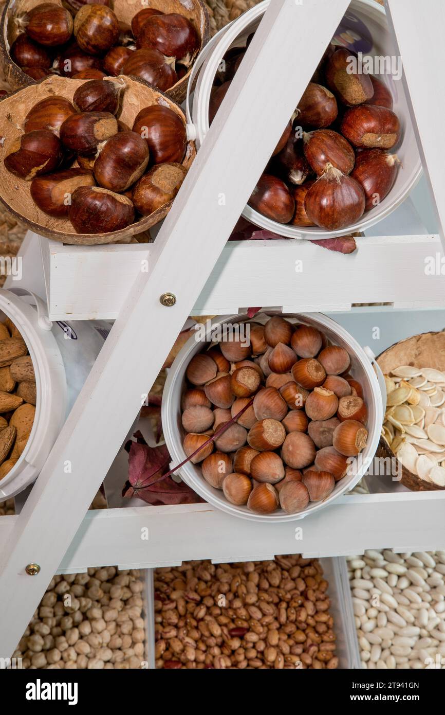 Homemade autumn/winter pantry with legumes and nuts. Shelf with beans ...