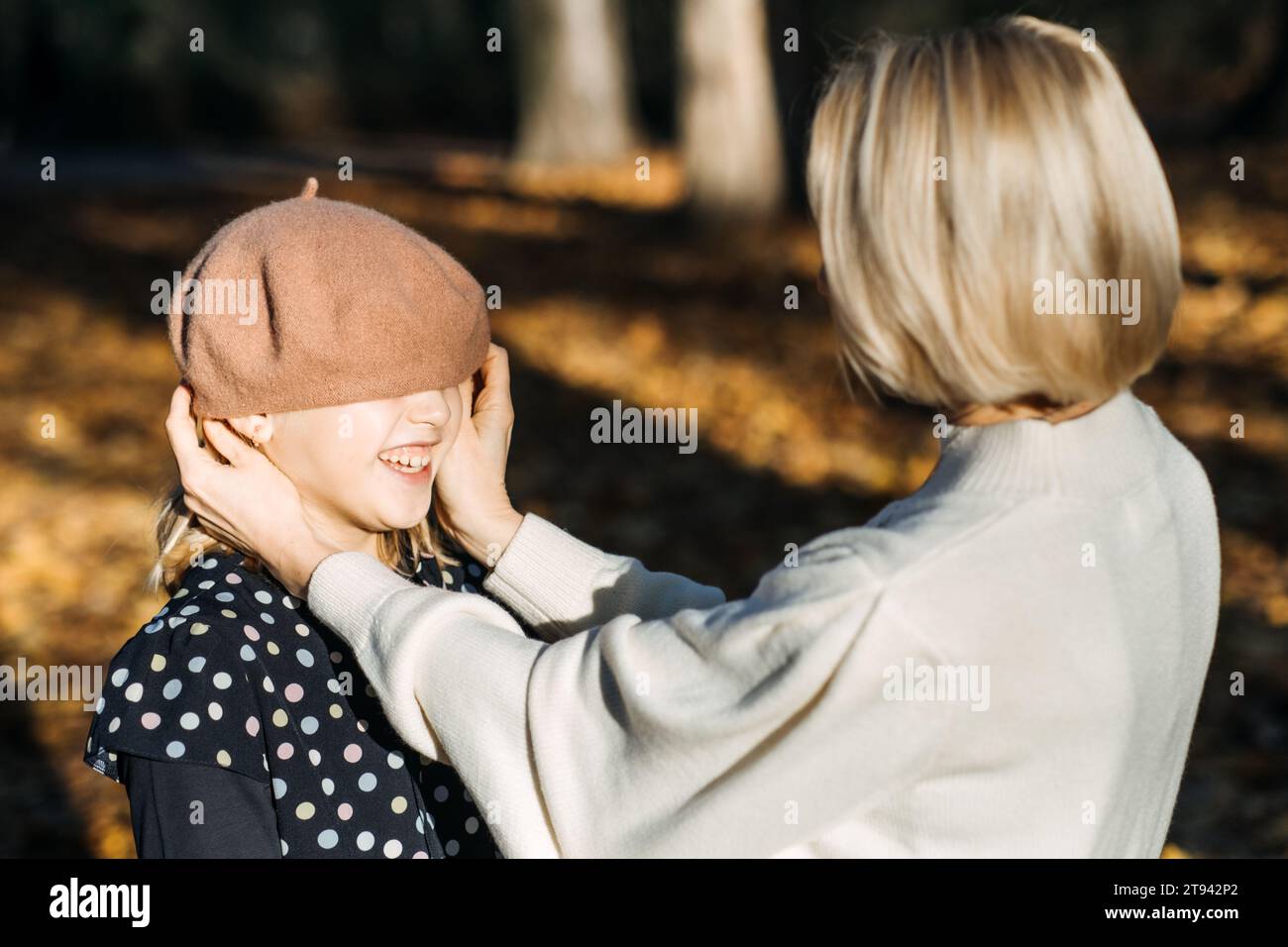 Autumn family walk. Heartwarming moment of smiling mother lovingly ...