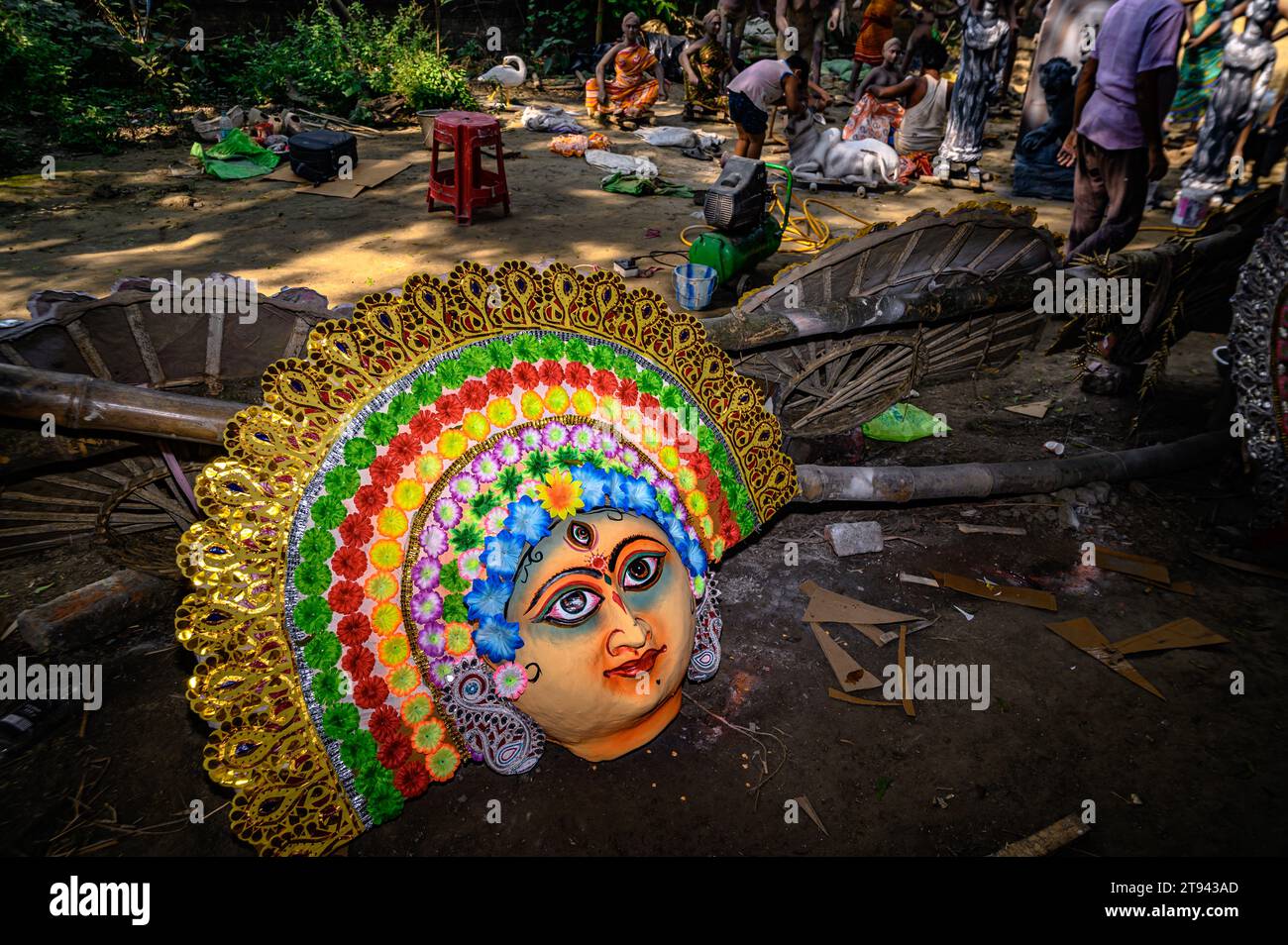 A village idol artist makes large color masks modeled after Purulia ...