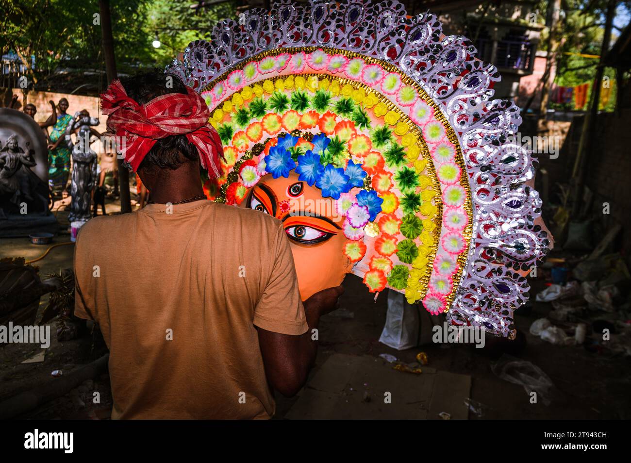 A village idol artist makes large color masks modeled after Purulia ...