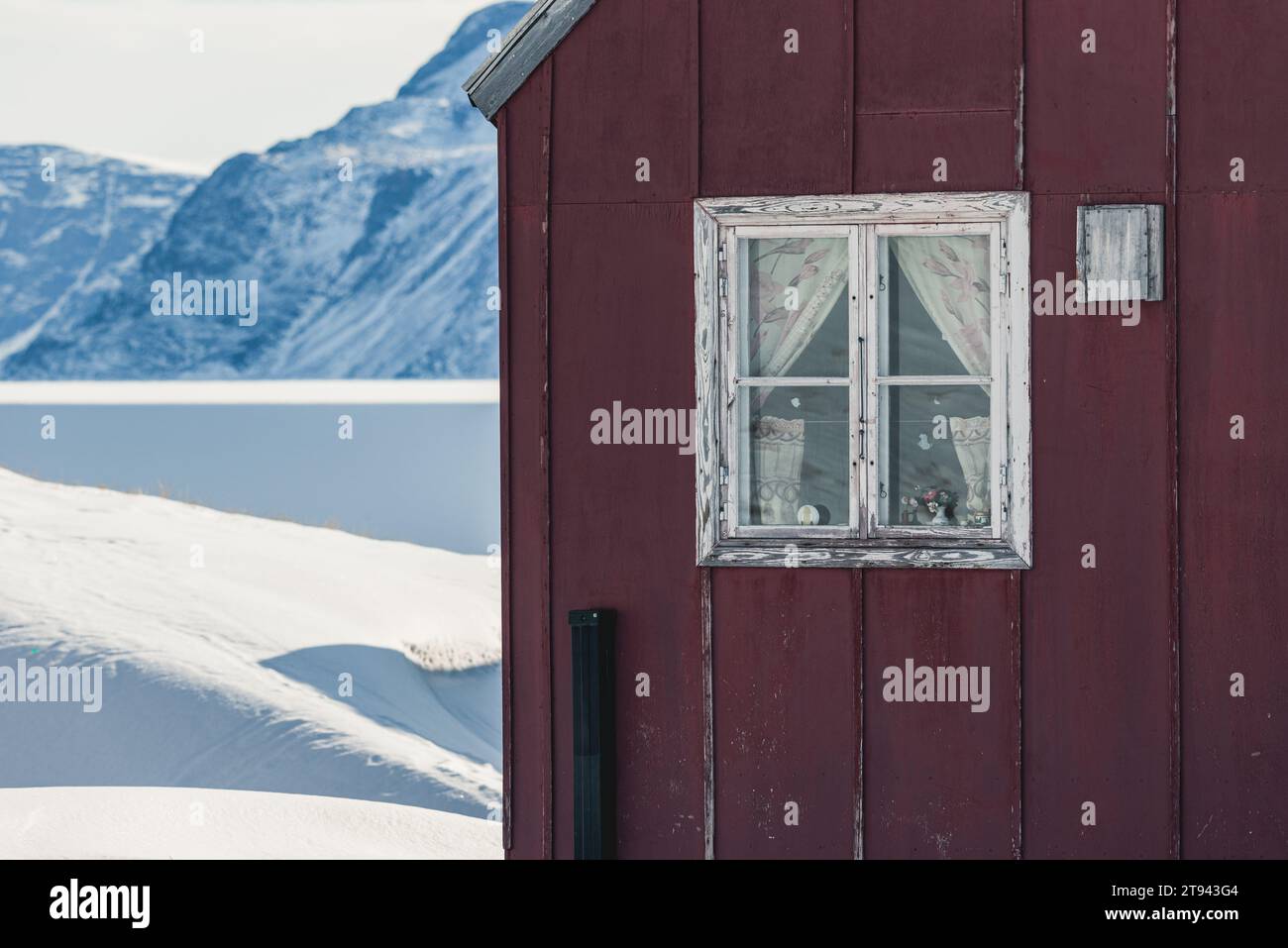 Winter cabin with red house in snowy Greenland mountains Stock Photo ...