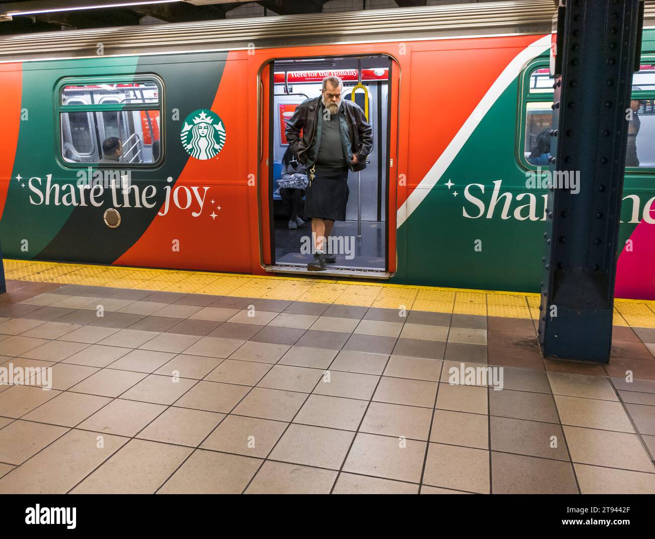 Starbucks advertising wrapped ÒEÓ train in the subway in New York on ...