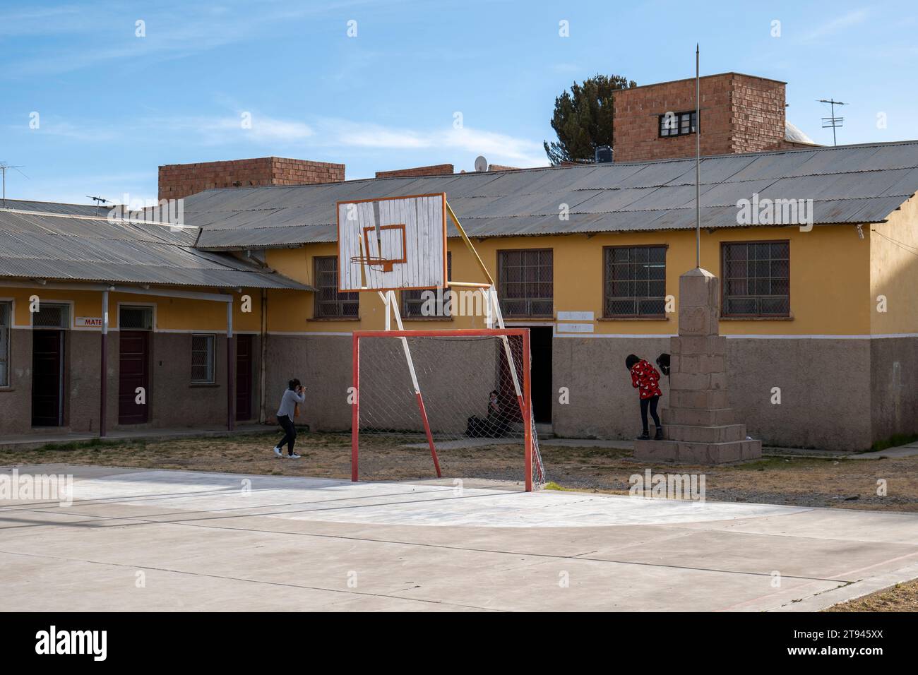 Kids Play in a School Yard with Basket Ball Court and Yellow Buildings ...