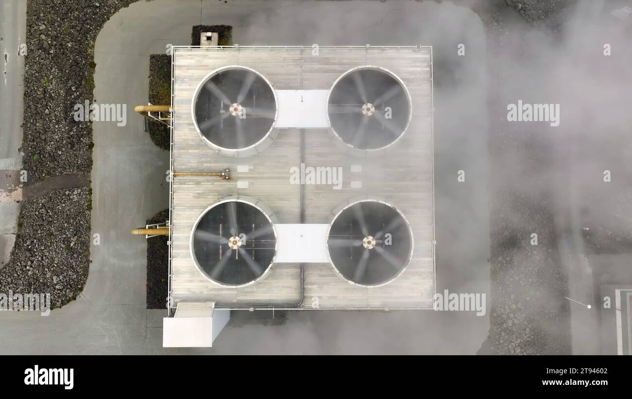 4K aerial video of geothermal energy plant, pipes and smoke chimneys ...