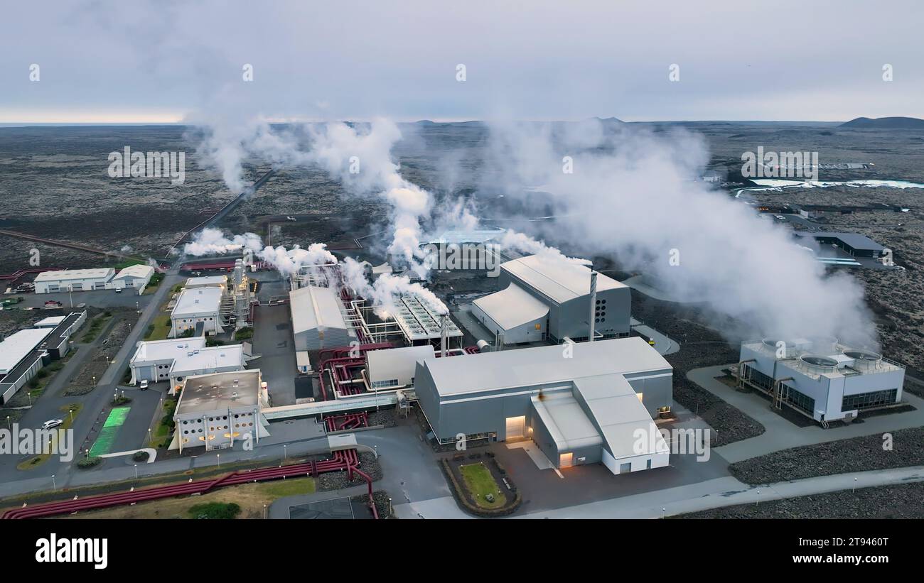 4K aerial video of geothermal energy plant, pipes and smoke chimneys ...