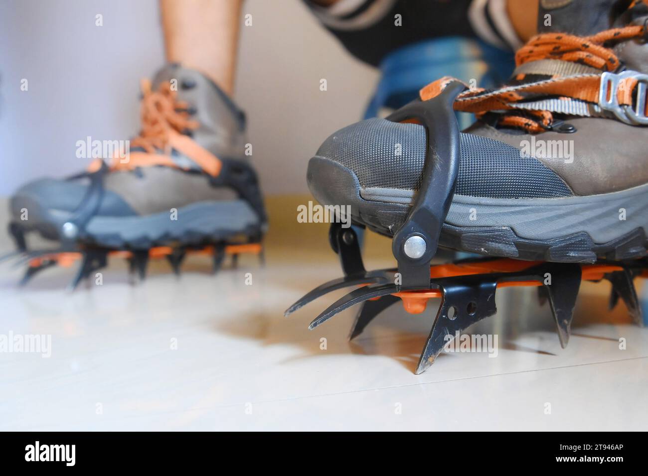 Aritra Roy, an IT professional and mountaineer, adjusting the spikes on ...
