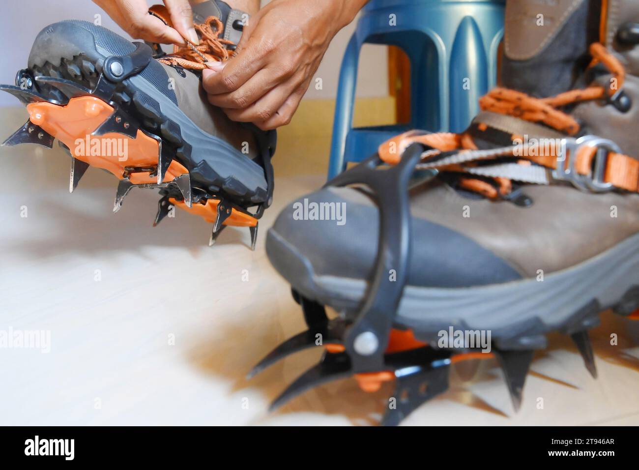 Aritra Roy, an IT professional and mountaineer, adjusting the spikes on ...